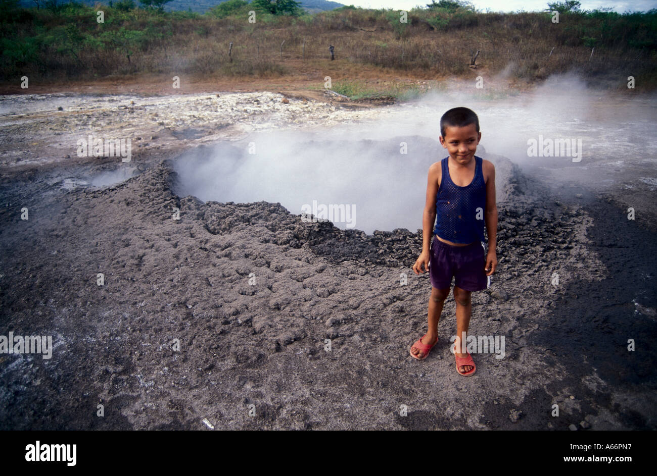 local boy stands near fumarole of lava flowing underground from Hoya ...