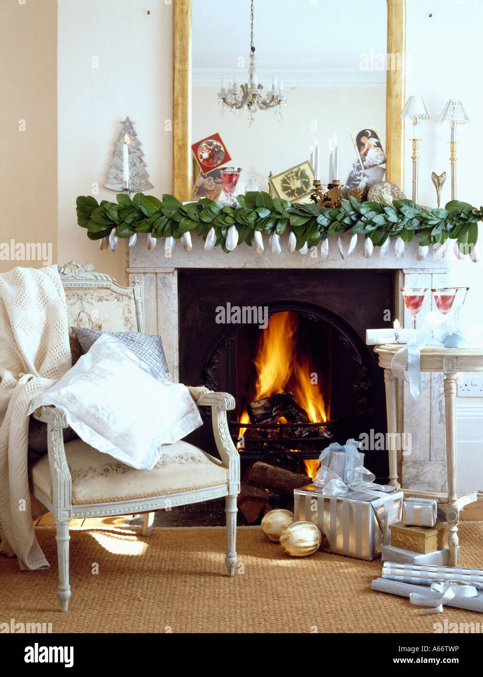 Traditional fireplace decorated for Christmas with fire in grate Stock ...