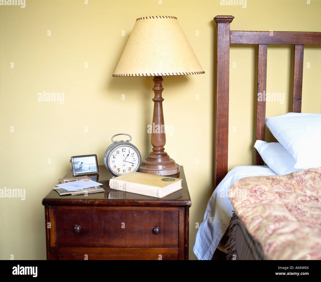 Lamp and clock on small drawers in forties bedroom Stock Photo - Alamy
