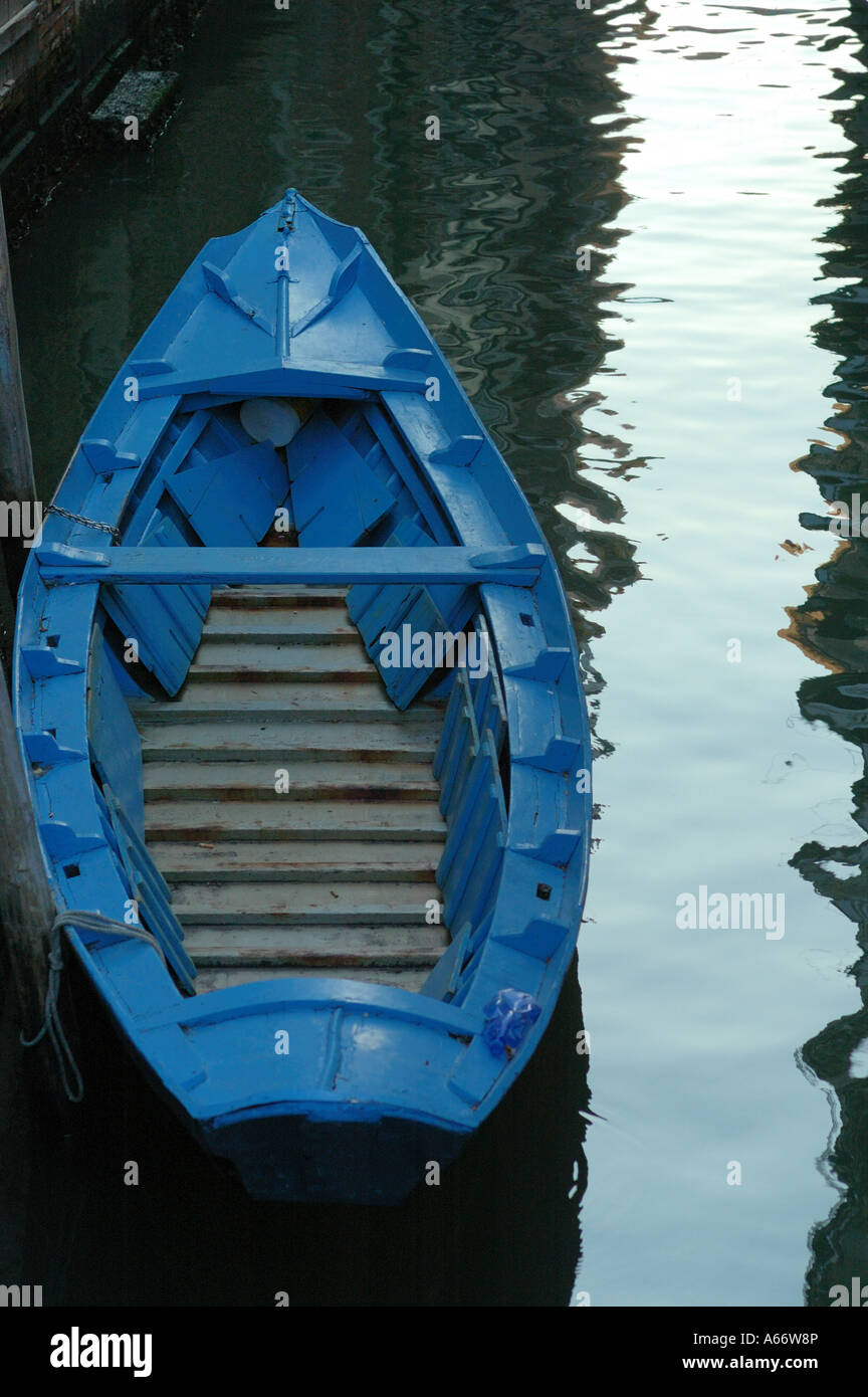 A royal blue traditional Venetian rowing boat in a canal Stock Photo ...