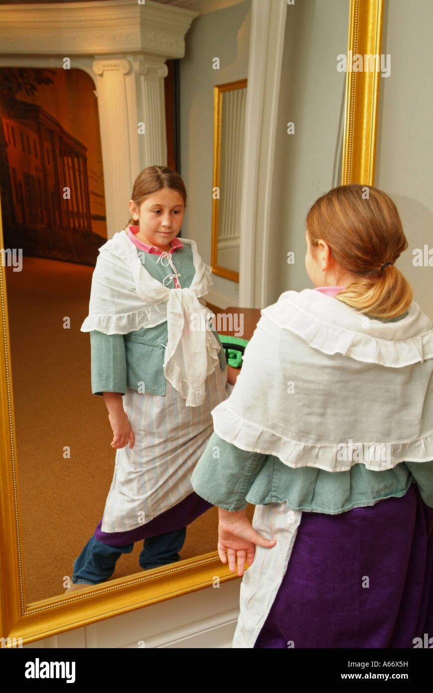 A young girl MR age 11 tries on a colonial era costume in a area that ...