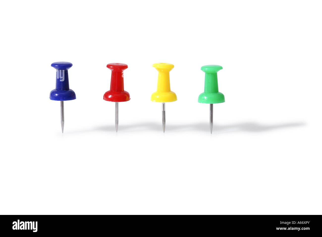 Four colorful tacks cut out on white background Stock Photo - Alamy