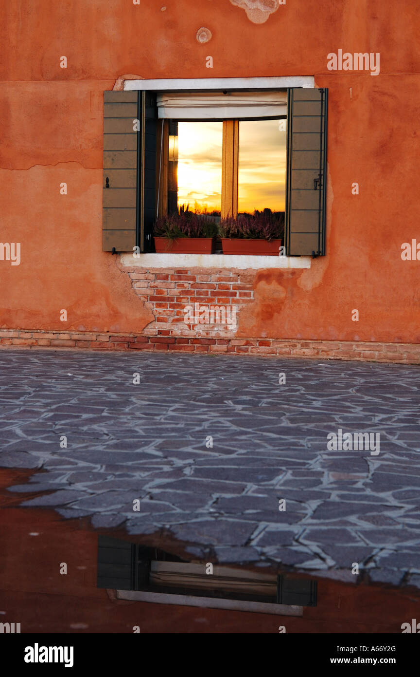 Window reflecting the sunset in Venice Italy Stock Photo - Alamy