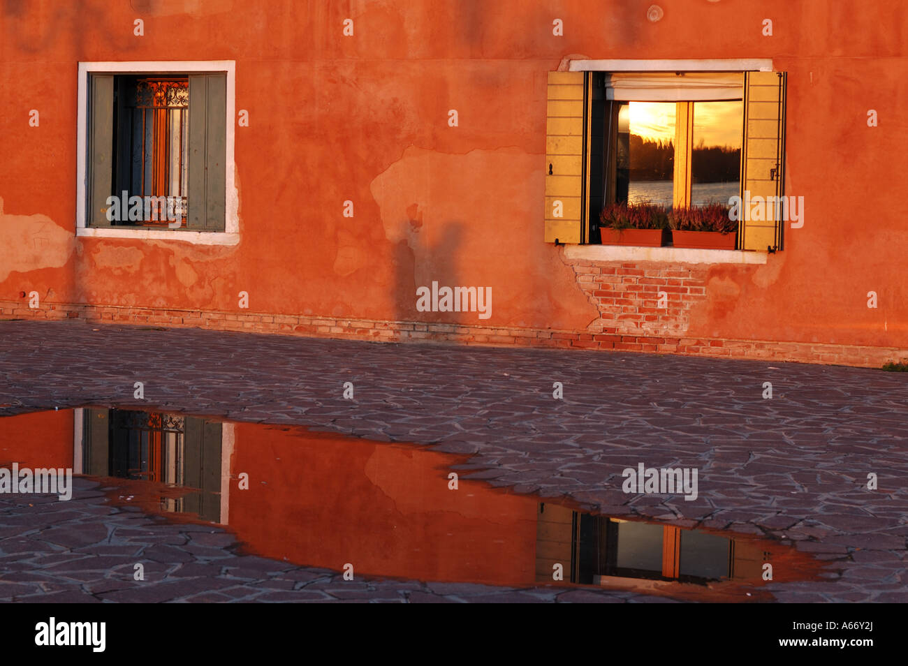 Window reflecting the sunset in Venice Italy Stock Photo - Alamy