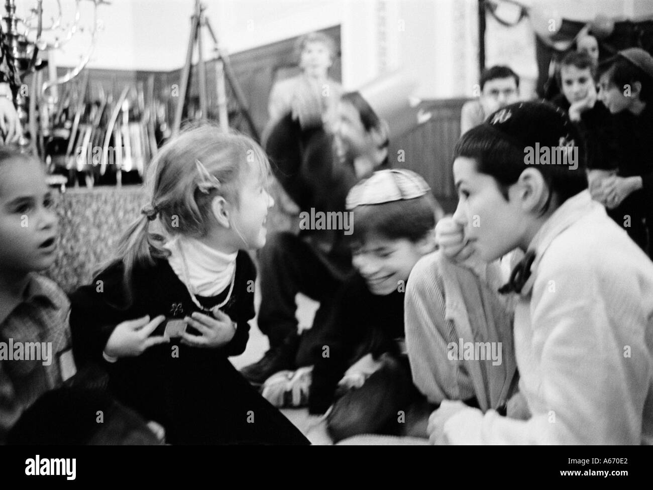 Jewish children two girls and two boys in kippa play during a Channukah ...