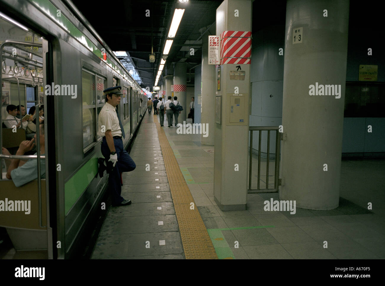 A Japanese train conductor enjoys a little down time at Shinagawa ...