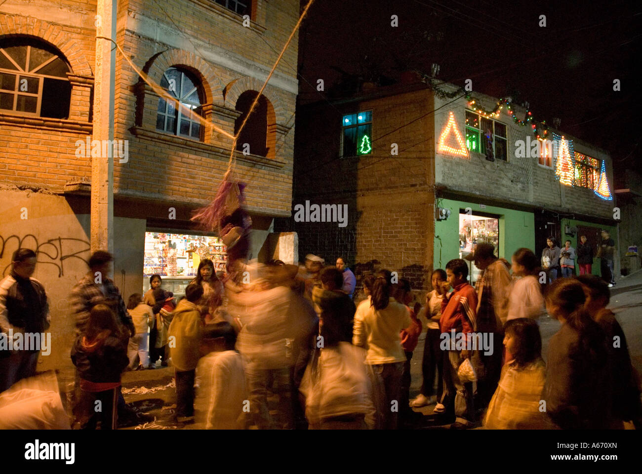 breaking the pinata - christmas game at night - mexico city Stock Photo ...