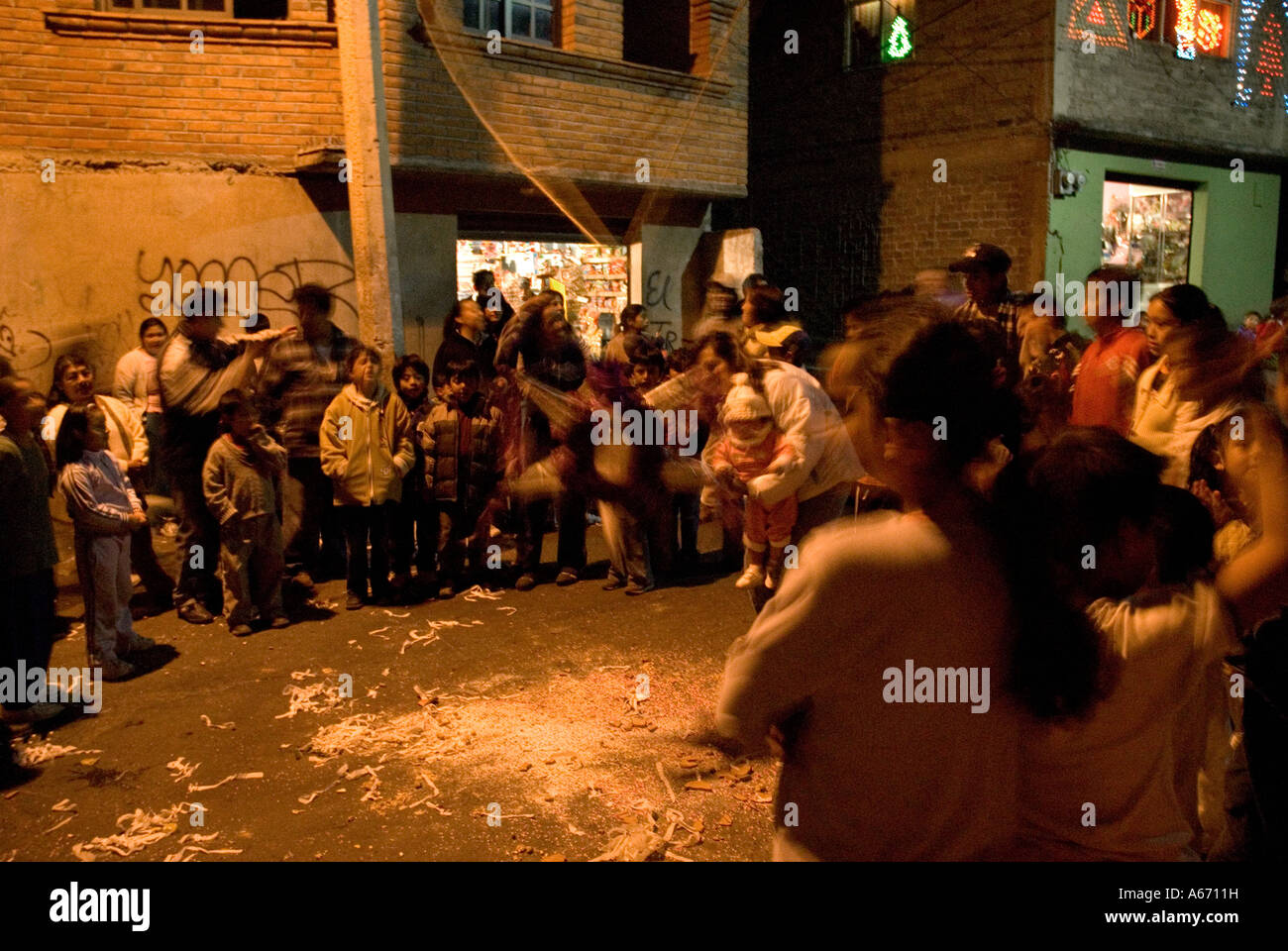 breaking the pinata - posada, the christmas game at night - mexico city ...