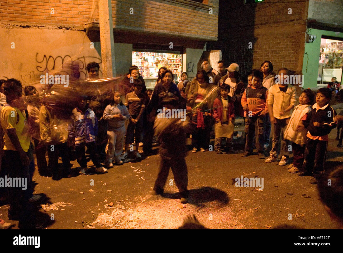 breaking the pinata - posada, the christmas game at night - mexico city ...
