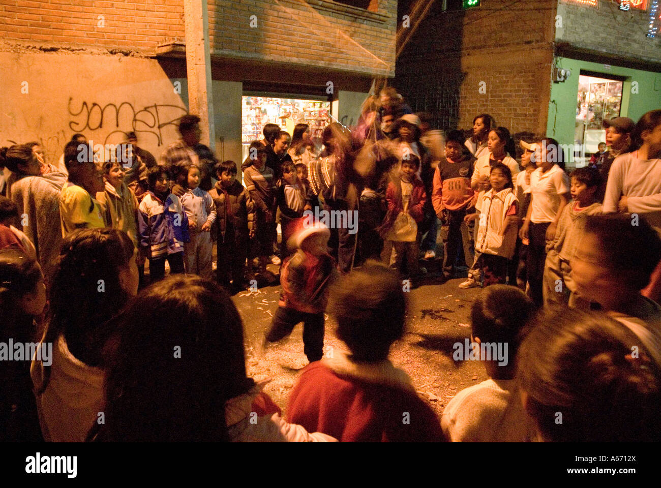 breaking the pinata - posada, the christmas game at night - mexico city ...