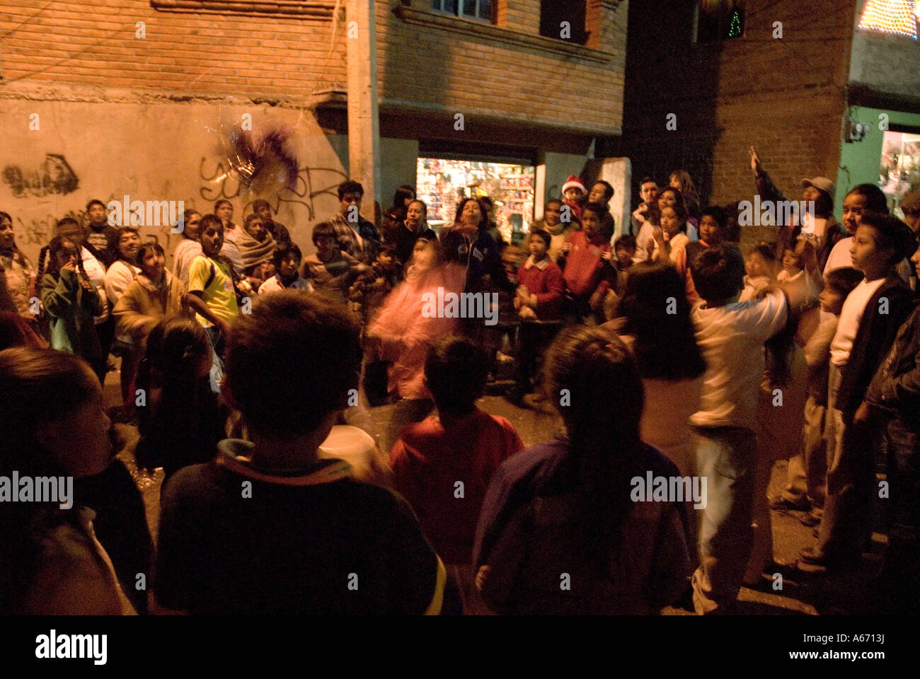 breaking the pinata - posada, the christmas game at night - mexico city ...