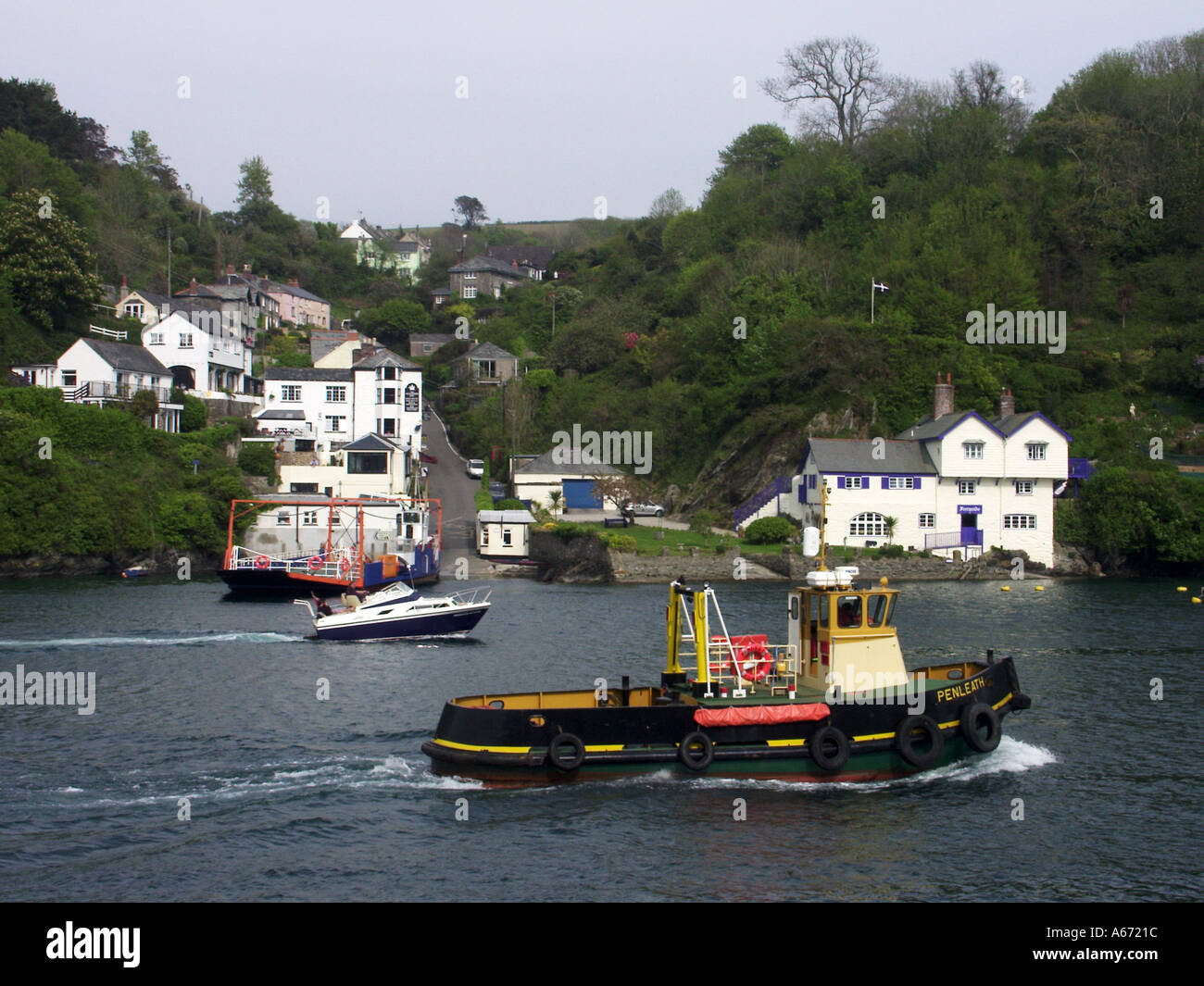 River Fowey and white waterside buildings in rural hillside landscape ...