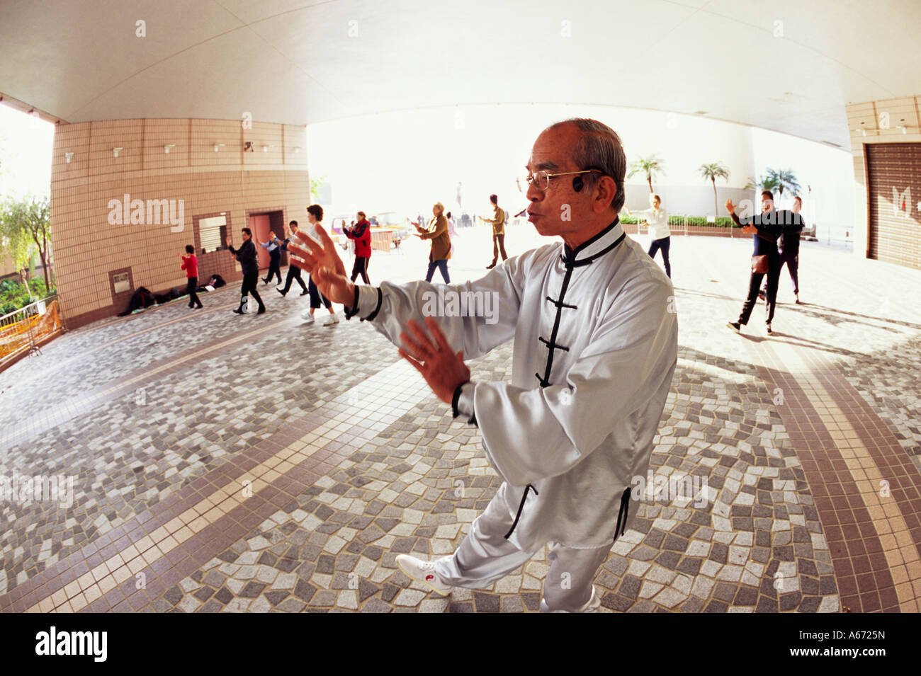 A group perform Tai chi near the Kowloon waterfront at Tsim Sha Tsui ...