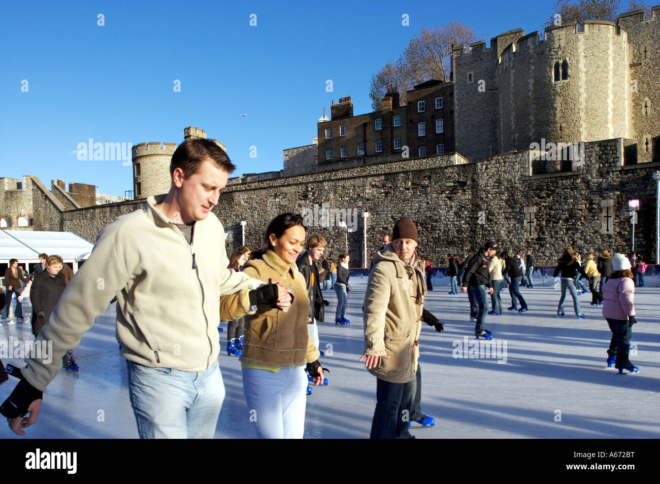 Skaters enjoy themselves on a temporary ice rink set up next to the ...