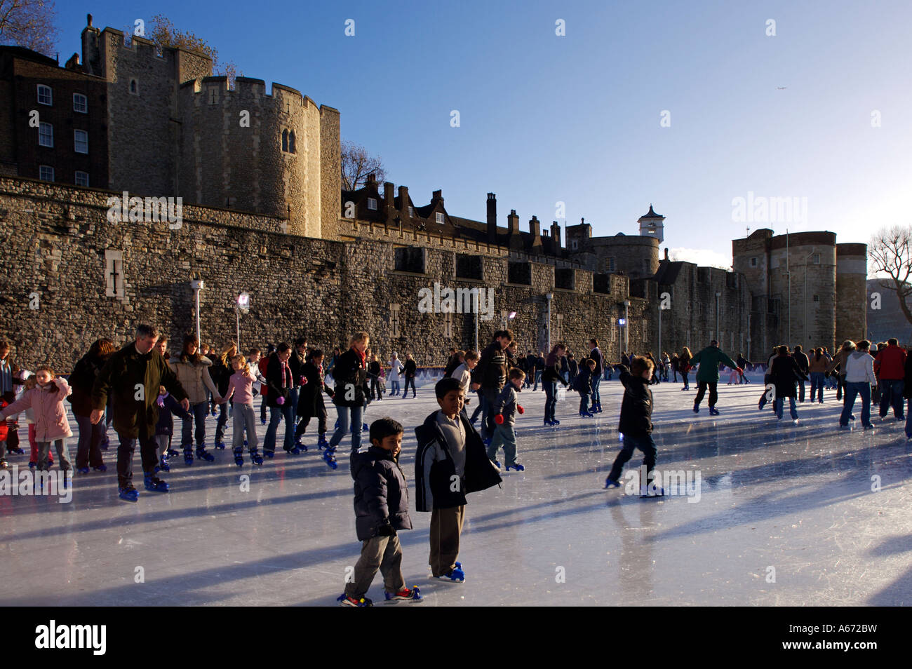 Skaters enjoy themselves on a temporary ice rink set up next to the ...