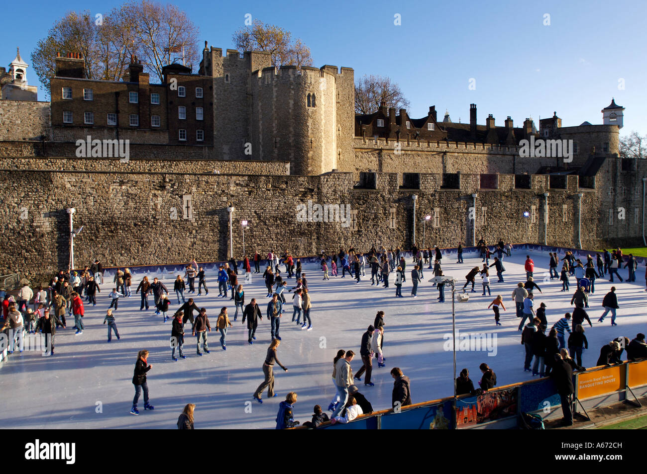 Skaters enjoy themselves on a temporary ice rink set up next to the ...