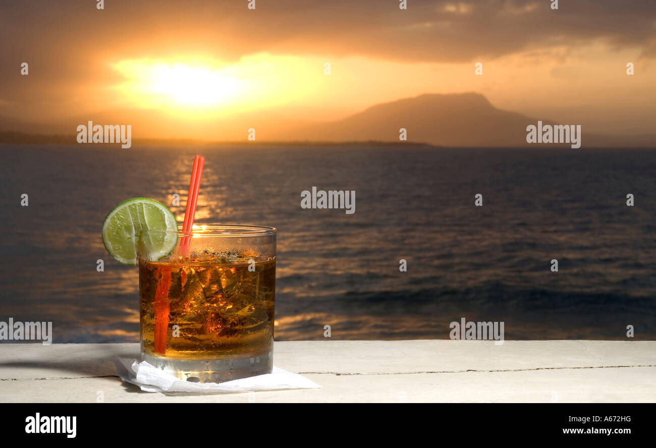 cocktail by the sea at sunset with island in distance dominican ...