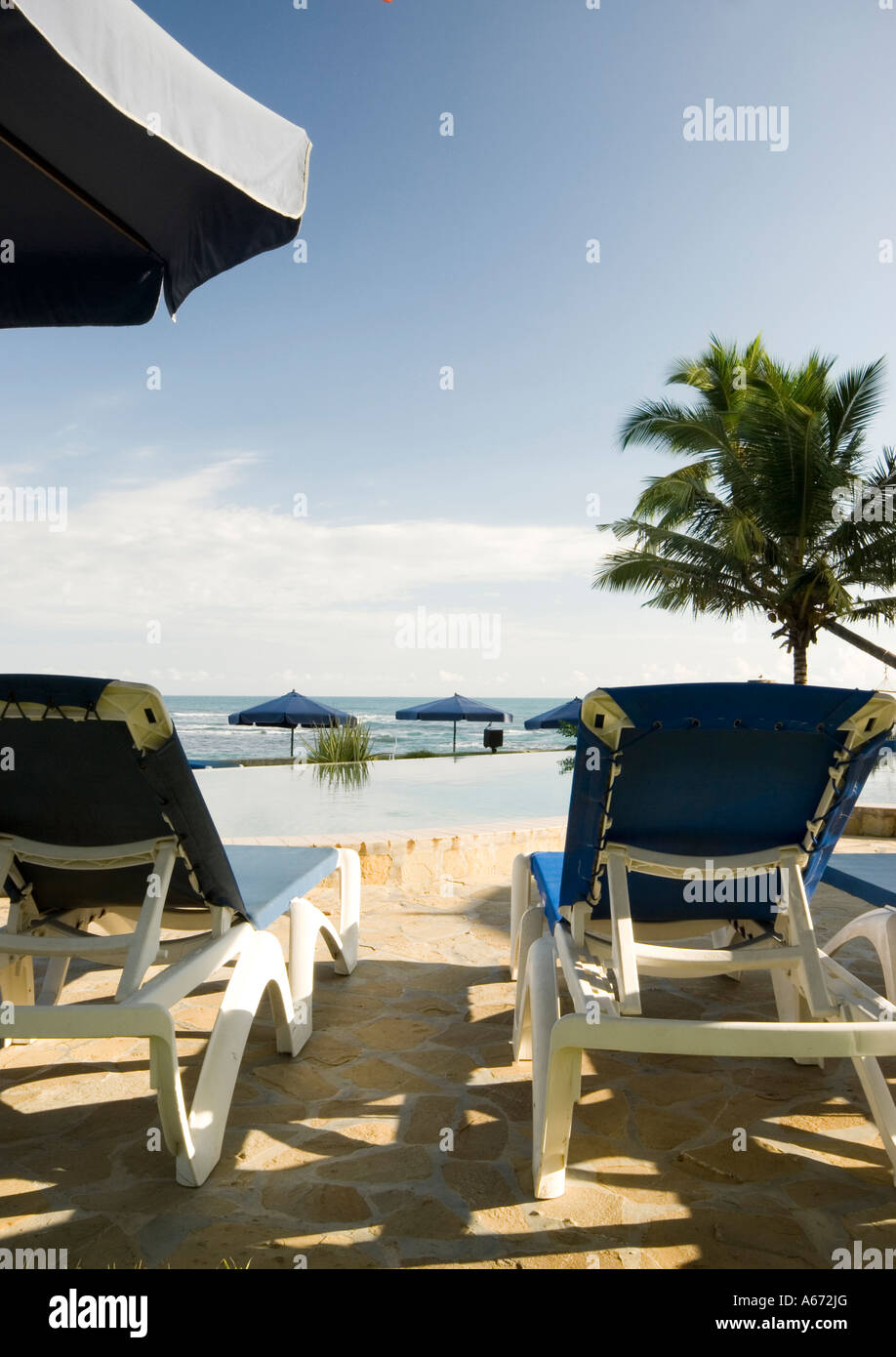 resort infinity pool with lounge chairs dominican republic Stock Photo ...