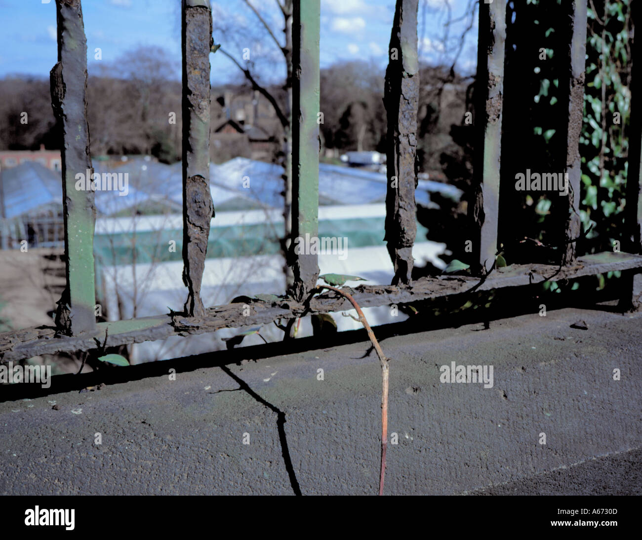 Severe corrosion of metal railings showing flaking and necking of the ...