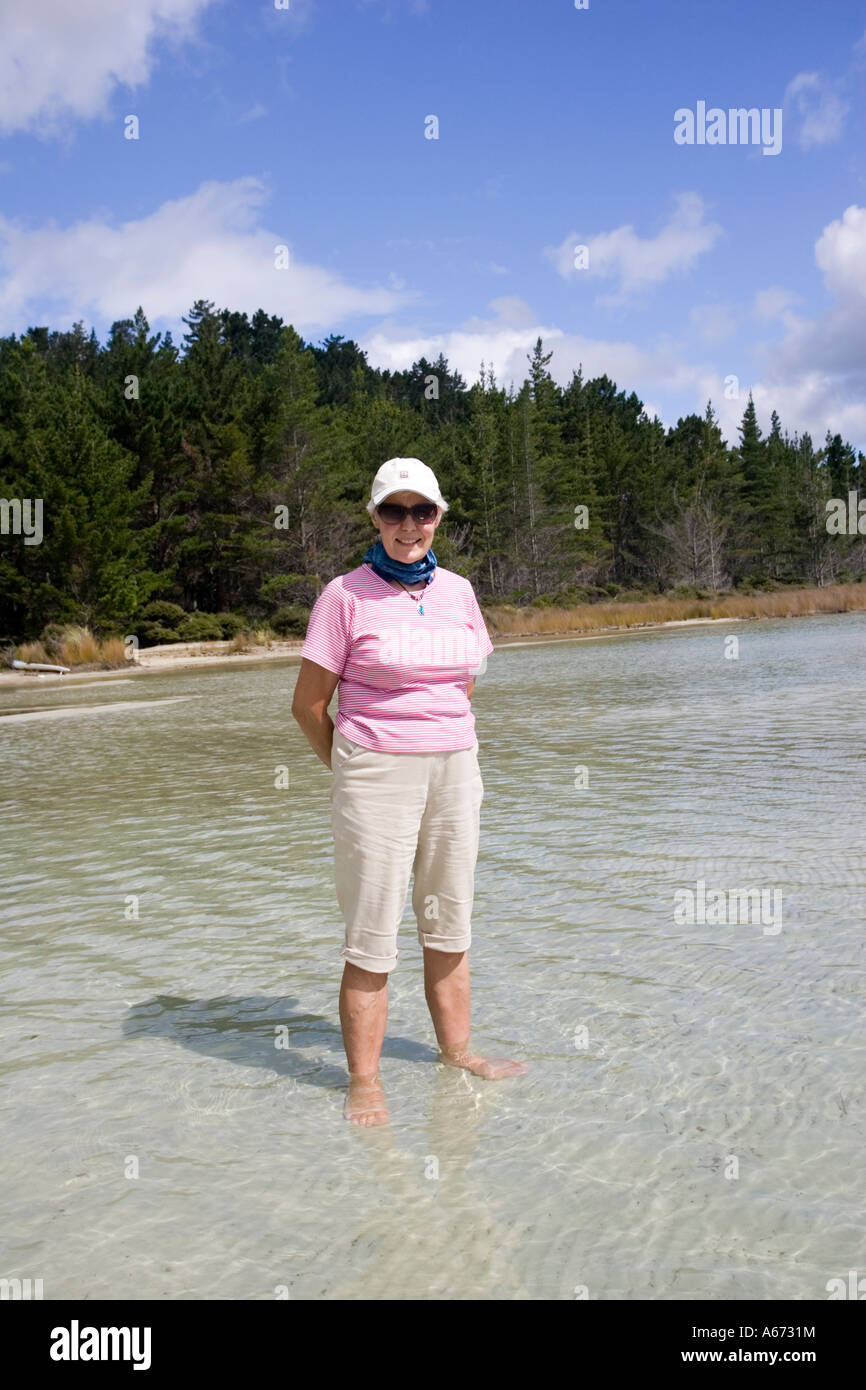 Tourist paddling in crystal clear water of Taharoa lake North Island ...