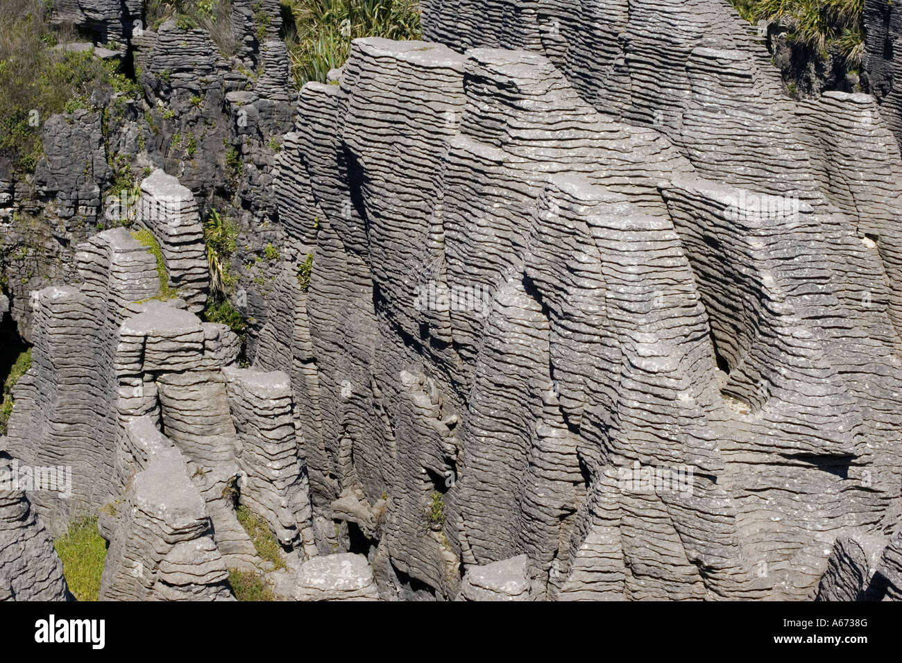 Layered limestone rocks in cliffs at Pancake Rocks Punakaiki South ...