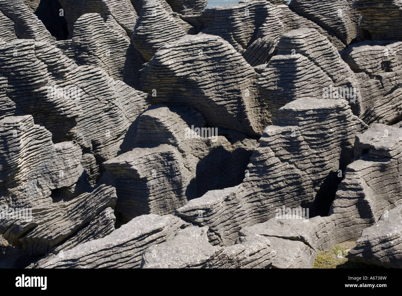 Characteristic layered Pancake rocks in limestone outcrops on cliffs ...