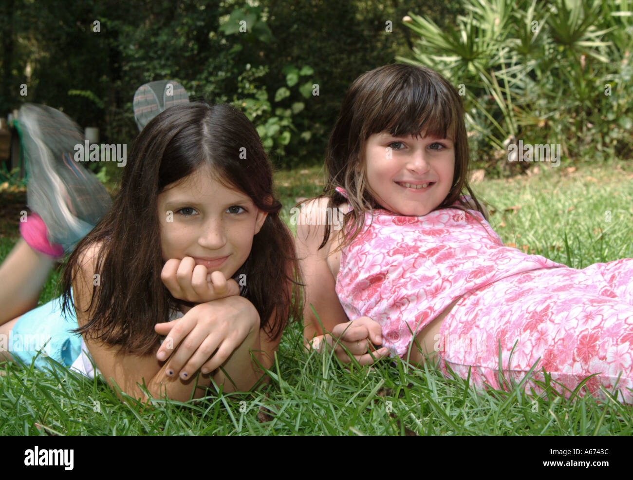 10 year old girl friends lying in grass Stock Photo - Alamy