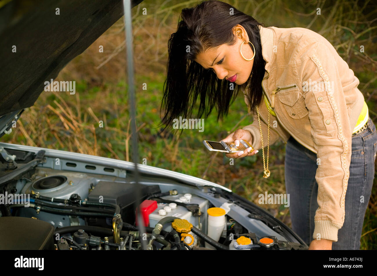 young woman with a car breakdown Stock Photo - Alamy