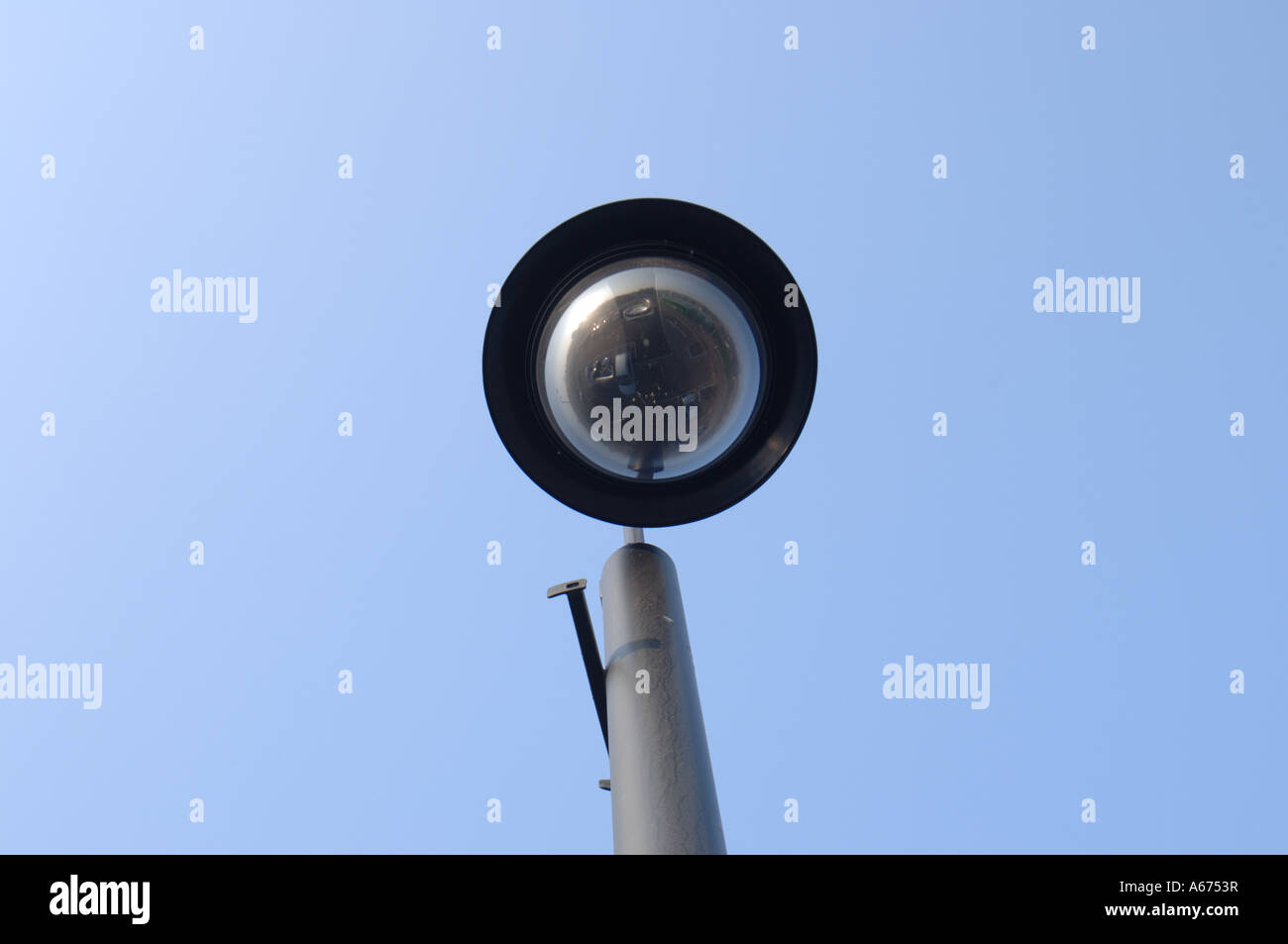 Looking up at a round CCTV camera against a clear blue sky Stock Photo ...
