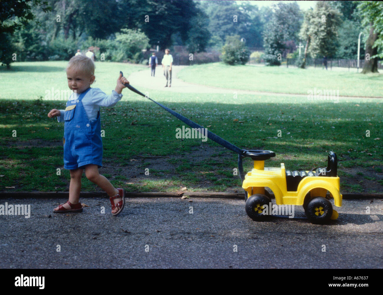 Toddler pulling toy car in Battersea Park, South London Stock Photo - Alamy