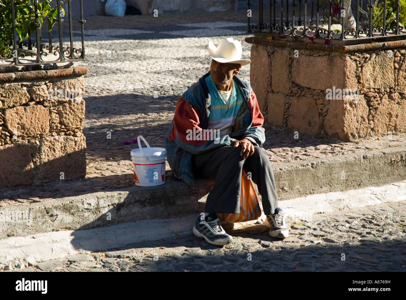 man seated in a step - taxco - mexico Stock Photo - Alamy