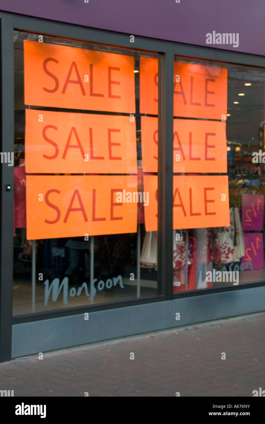High street shop window with January sales banner posters advertising ...