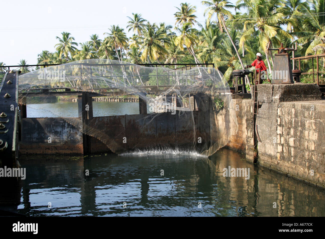 Fisherman casting his circular net at a lock gate in the Kerala ... Fisherman casting his circular net at a lock gate in the Kerala ...