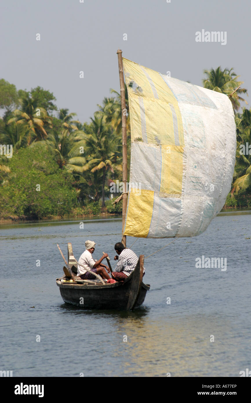 A fishing boat with it's patchwork sail on the backwaters of Kerala ...