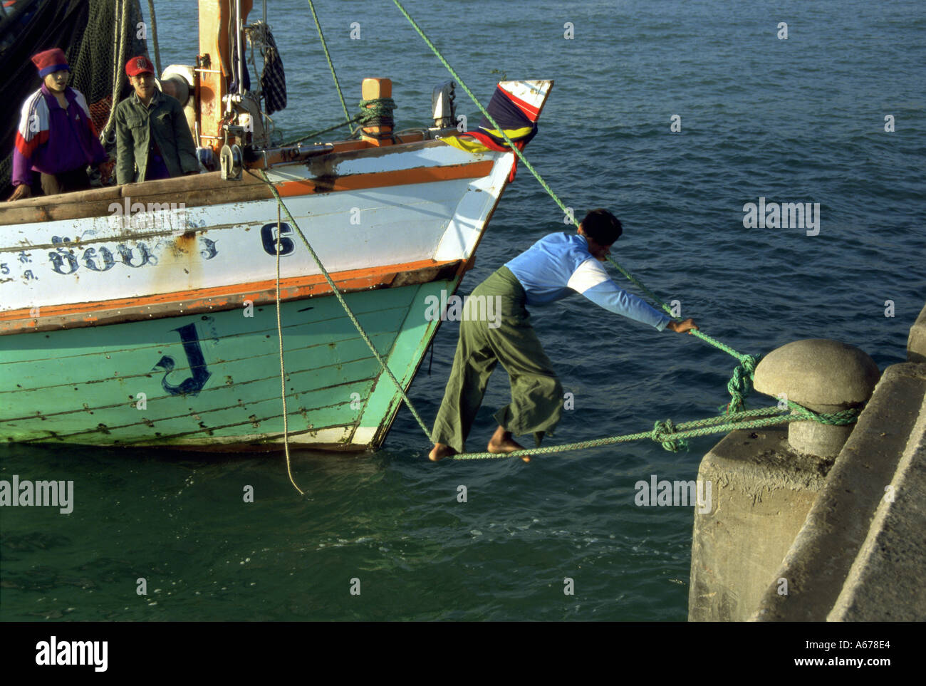 Fisherman getting aboard Stock Photo - Alamy