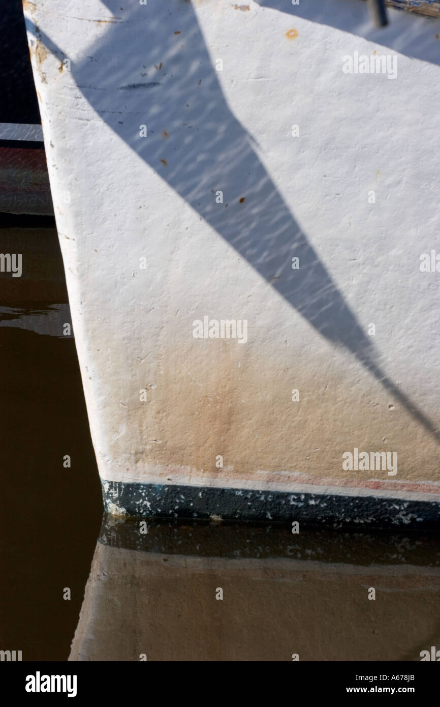 Close up of fishing boat bow with reflection on water Stock Photo - Alamy
