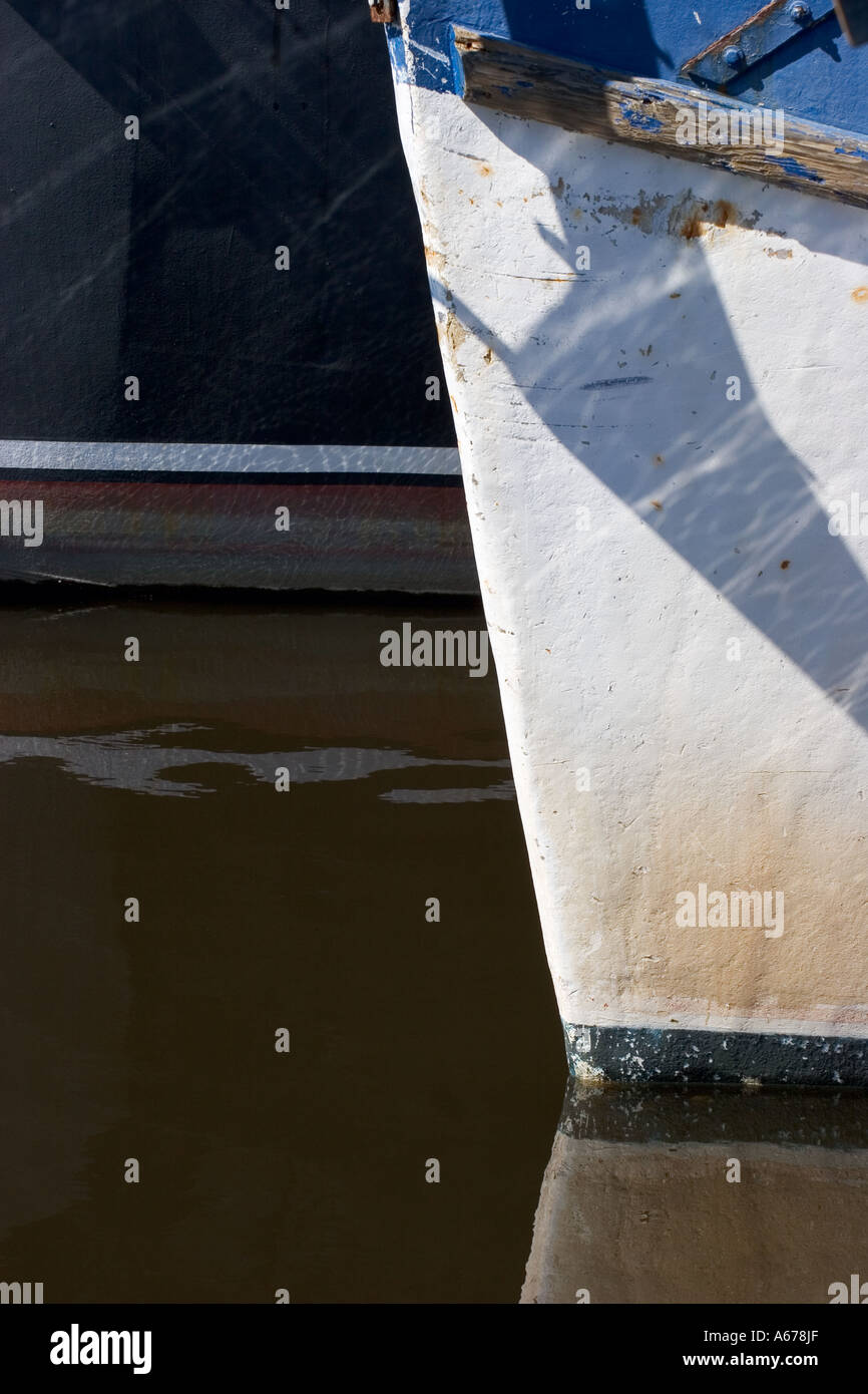 Close up of fishing boat bow with reflection on water Stock Photo - Alamy