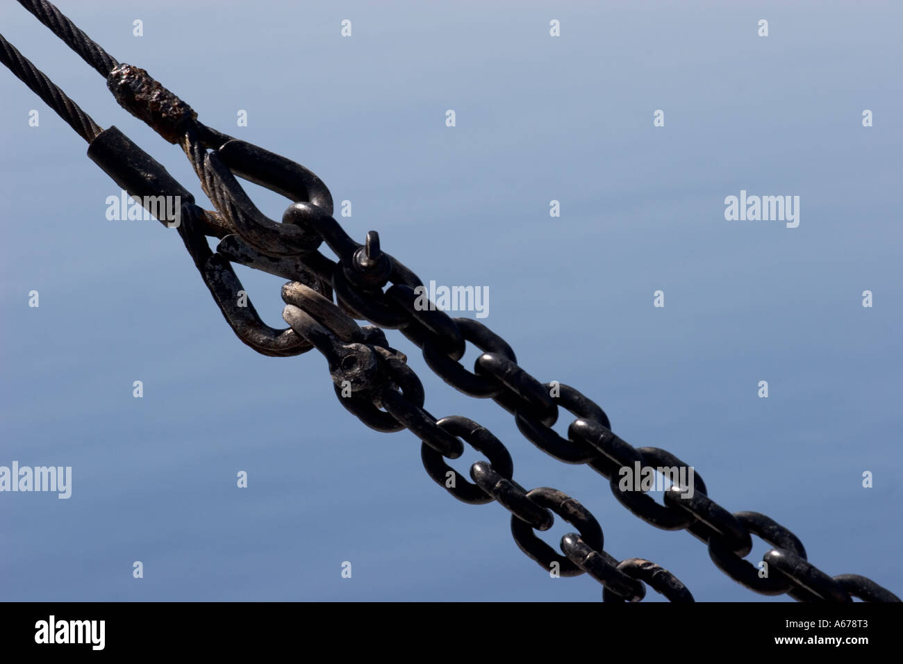 Chains and cables against cool blue water Stock Photo - Alamy