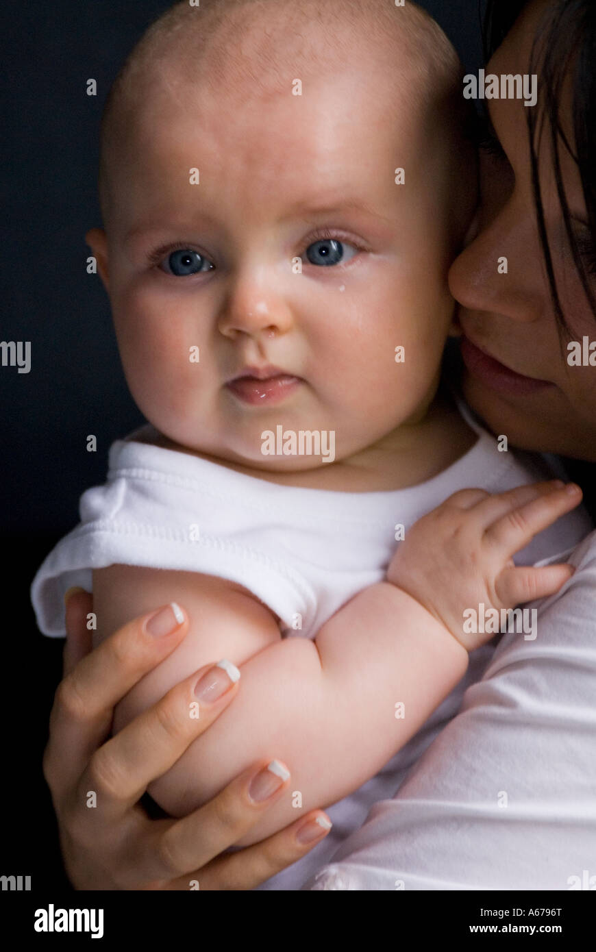 Mother comforts baby Stock Photo - Alamy