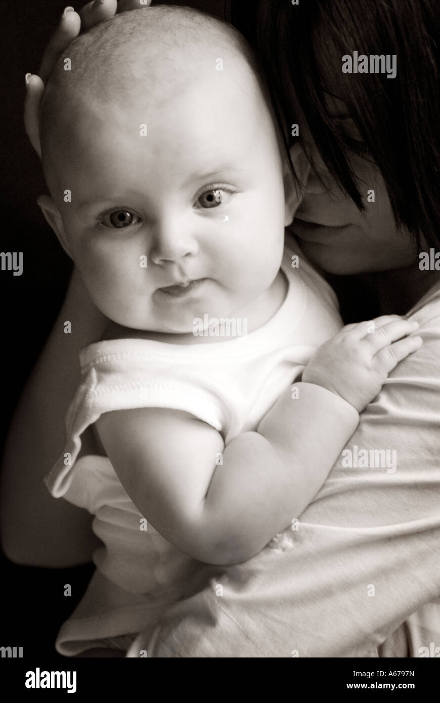 Mother comforts baby Stock Photo - Alamy