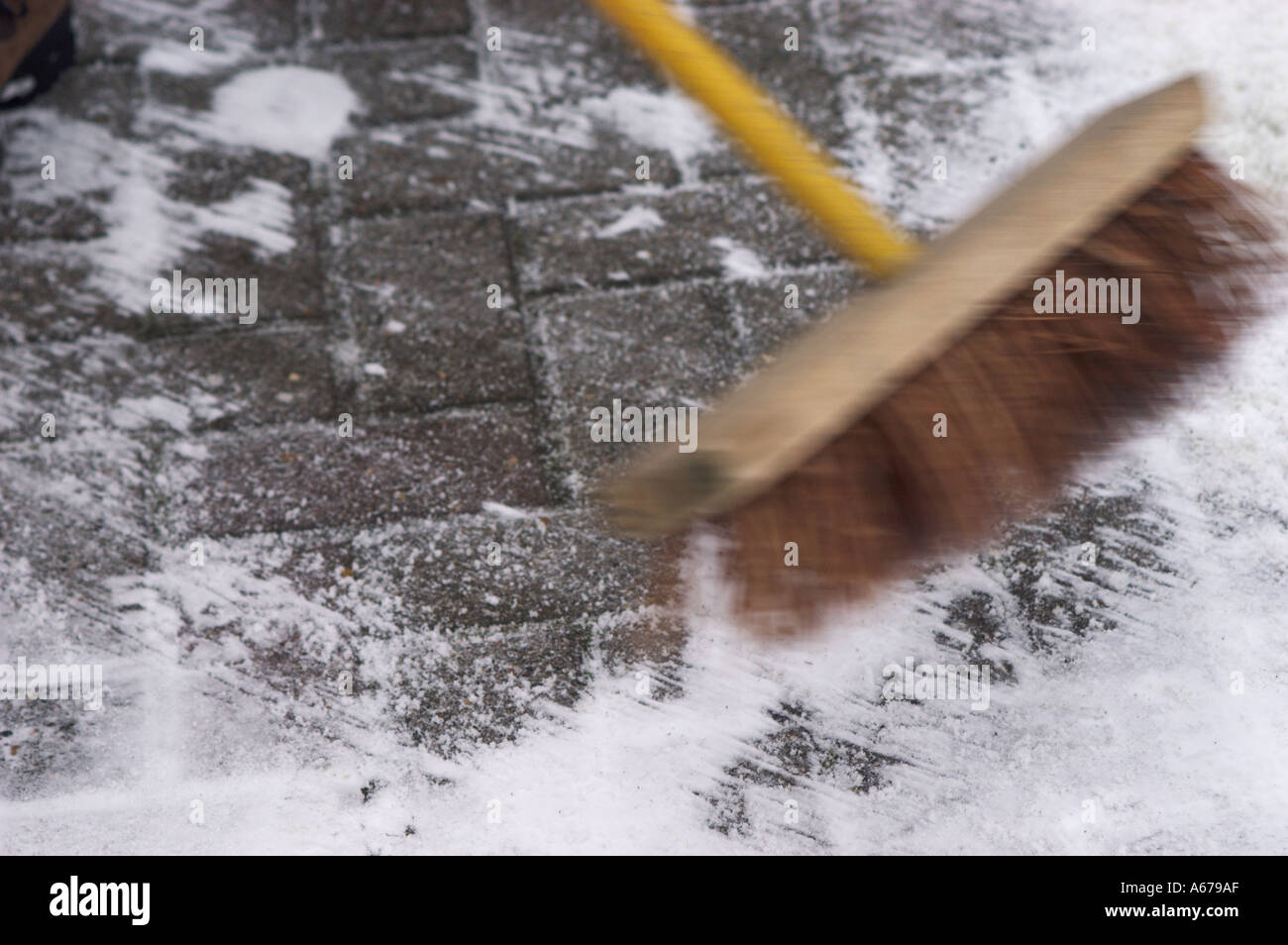 Sweeping the snow Stock Photo - Alamy