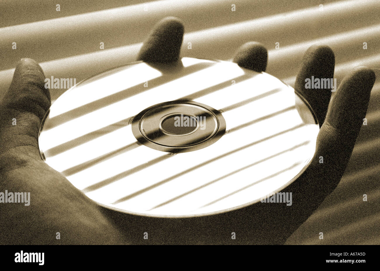 Information Hand holding computer CD disc Stock Photo - Alamy