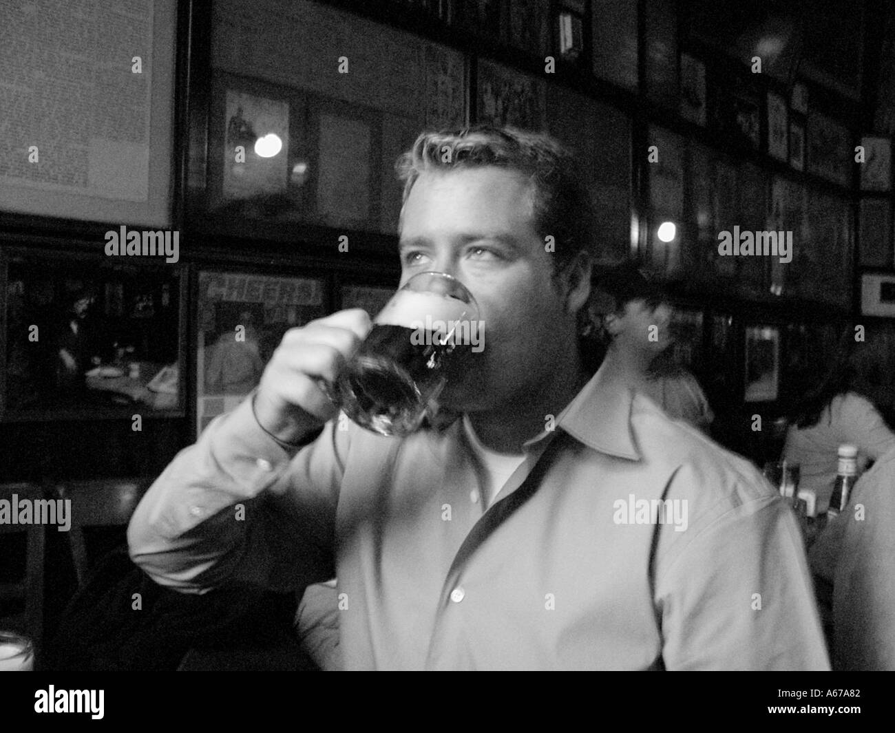 Young man drinking Beer in a bar Stock Photo - Alamy