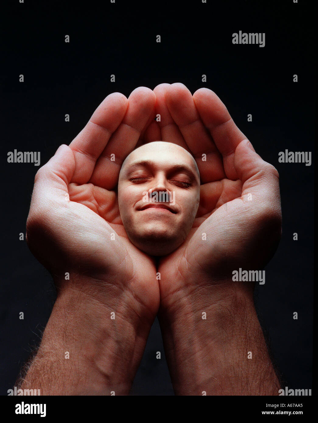 Hands holding a smiling man s face Stock Photo - Alamy