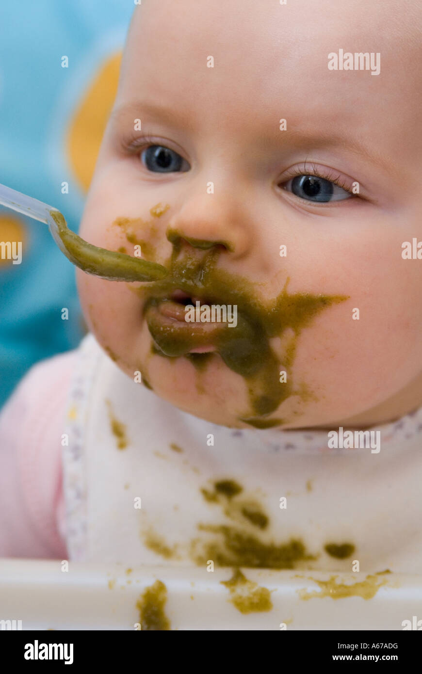 A baby with baby food smeered around his face Stock Photo - Alamy