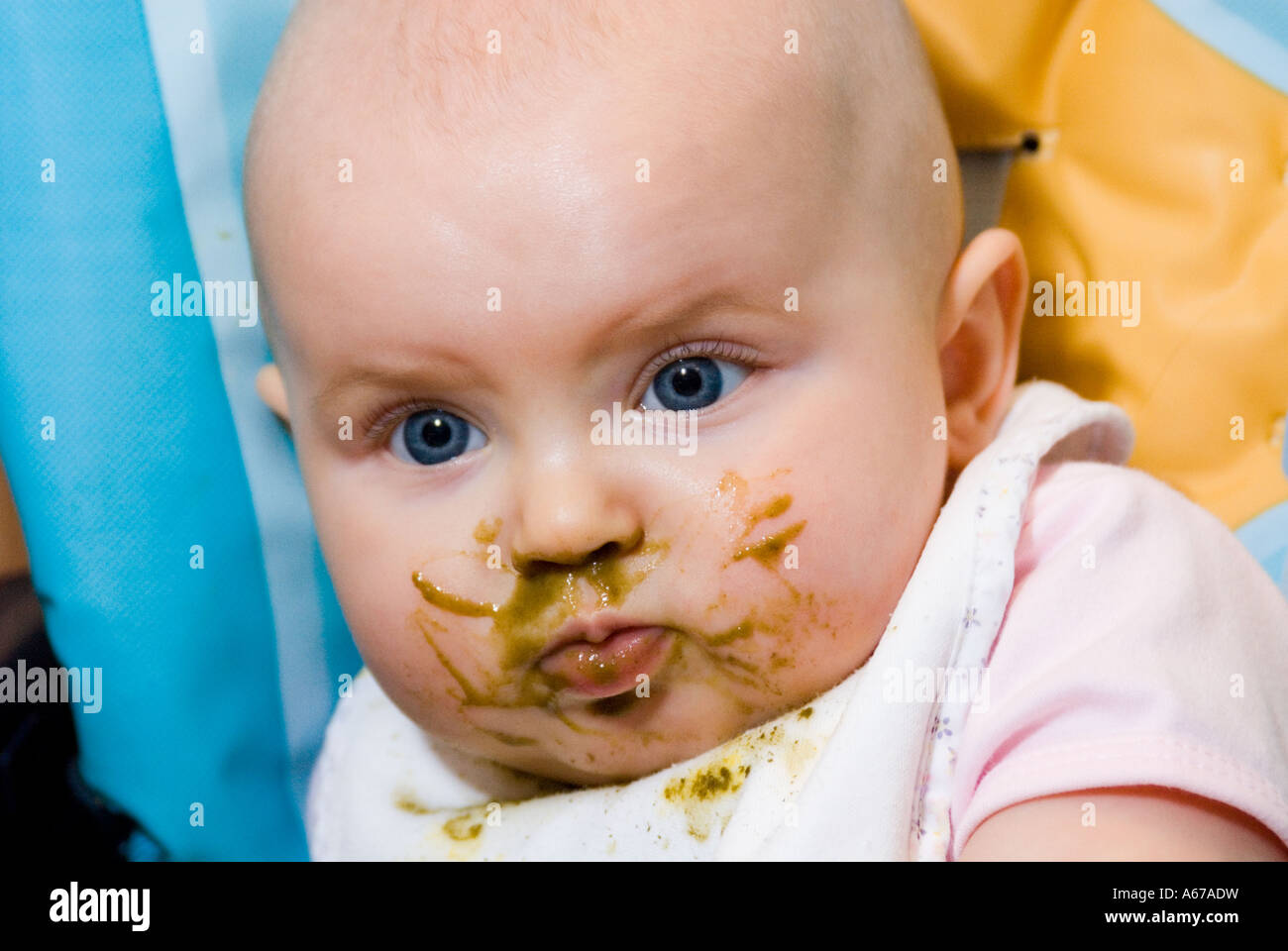 A baby with baby food smeered around his face Stock Photo - Alamy
