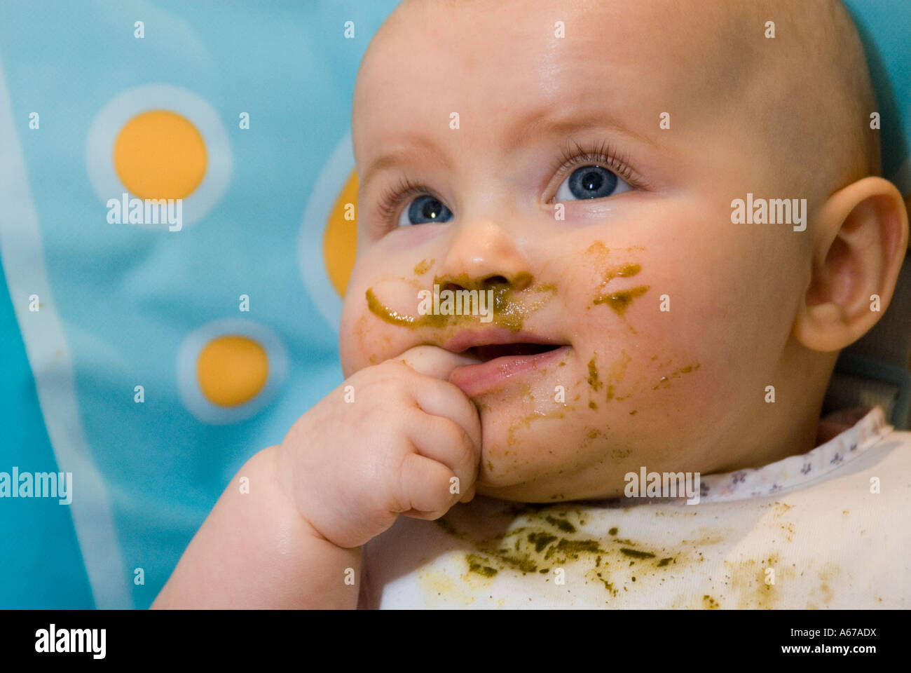A baby with baby food smeered around his face Stock Photo - Alamy
