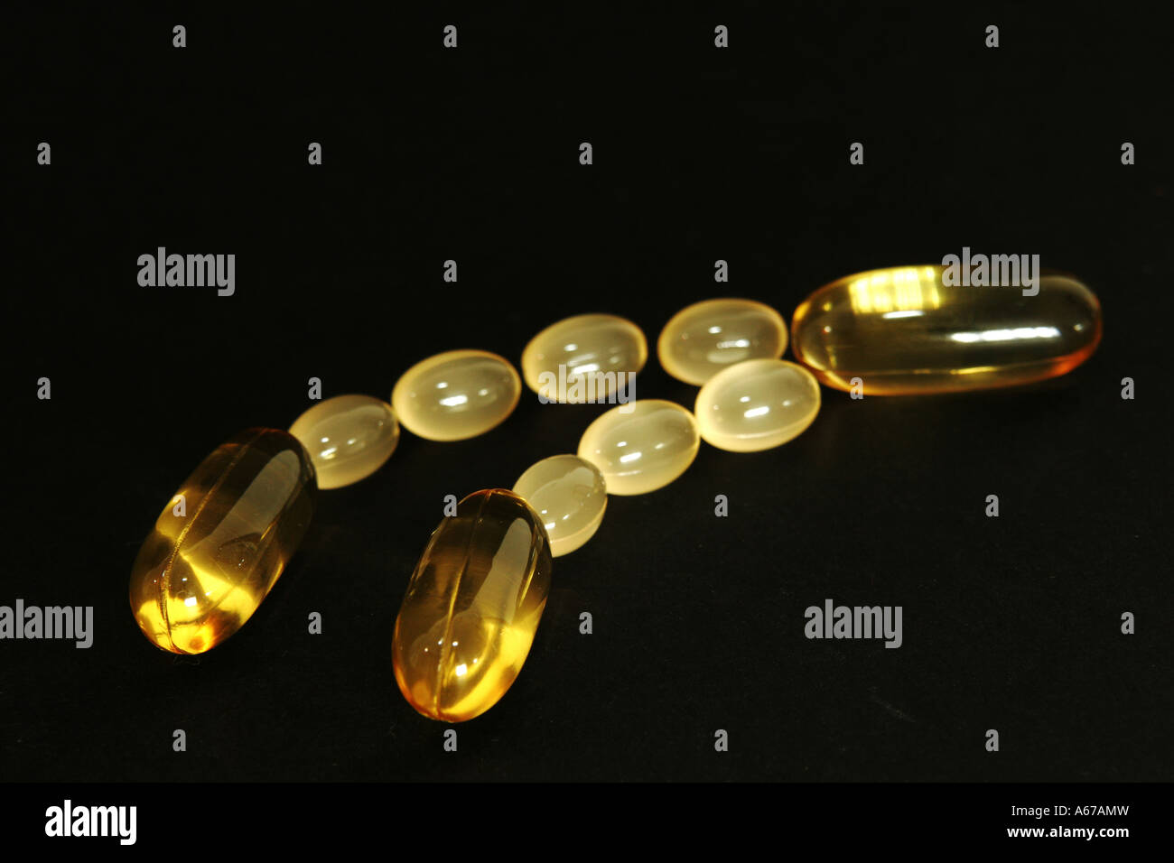 A line of oil capsules Stock Photo - Alamy