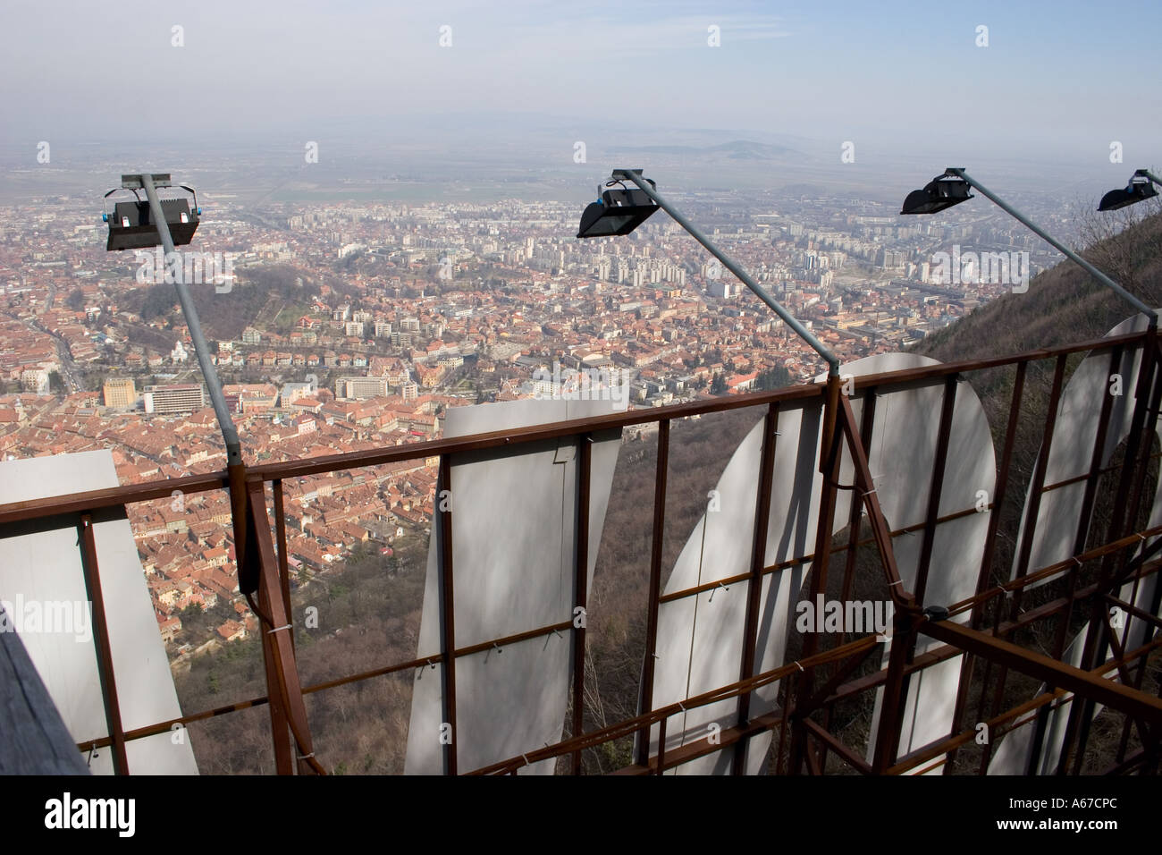 Close up of the sign BRASOV on mountain with city of Brasov in ...