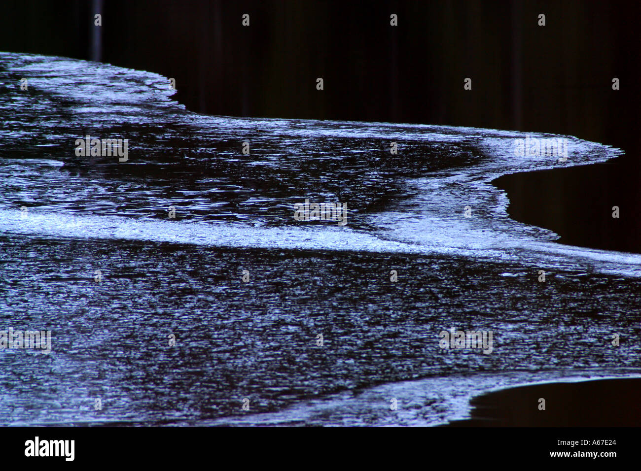 Still water partially frozen over with ice Stock Photo - Alamy